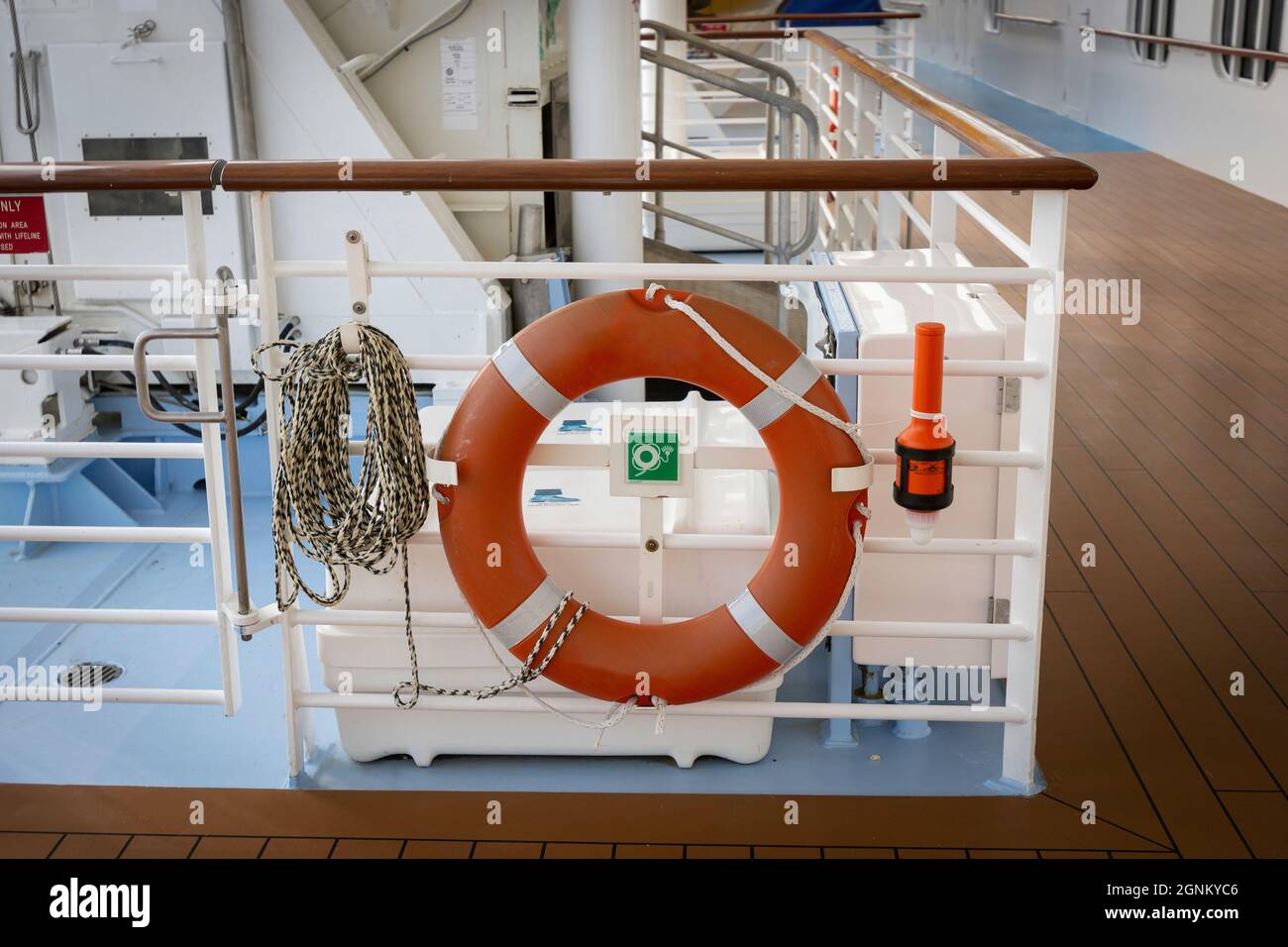 Round orange life saver tied on railings on ship Stock Photo - Alamy