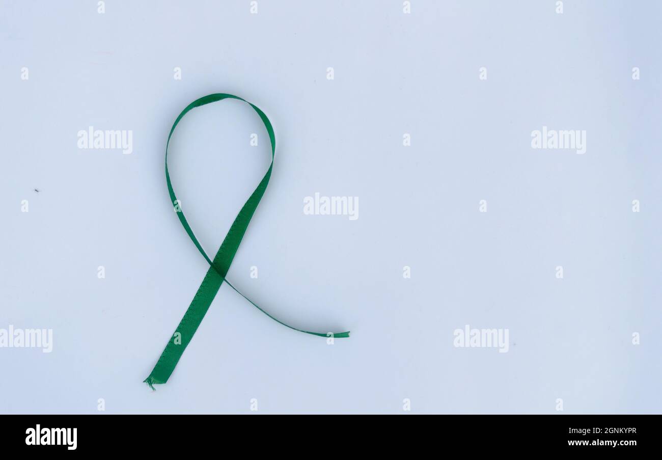 Green Awareness Ribbon on white background. Table top view. Health care ...