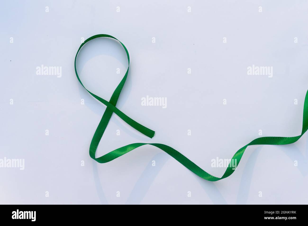 Green Ribbon on white background. Table top view. copy space for text ...