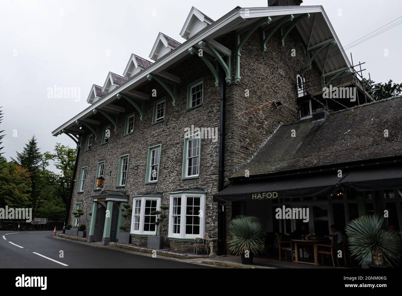 Traditional Welsh stone building with distinctive green timber canopy ...