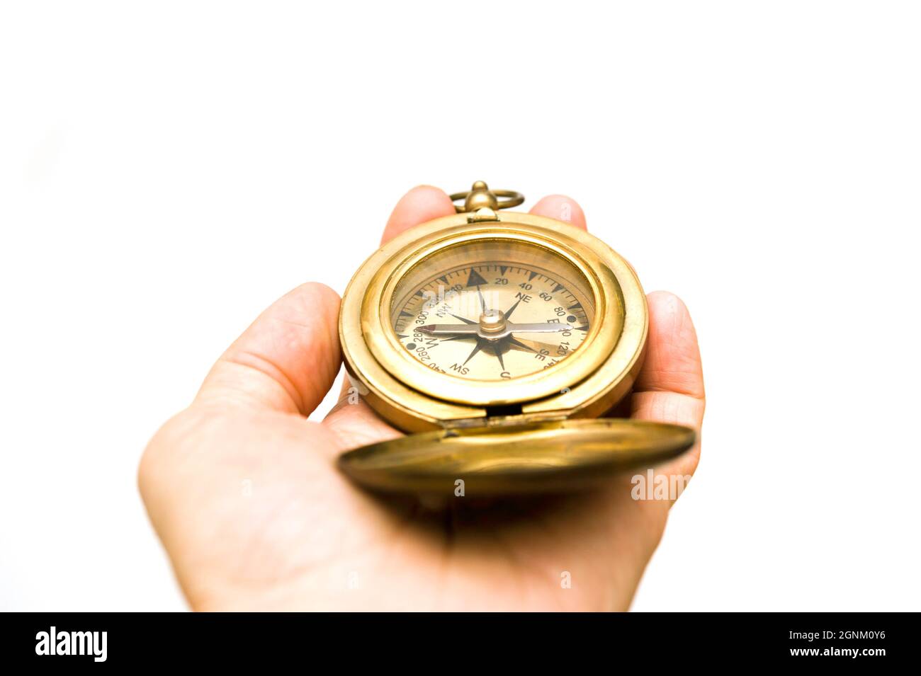hand holding an antique brass compass for direction Stock Photo - Alamy