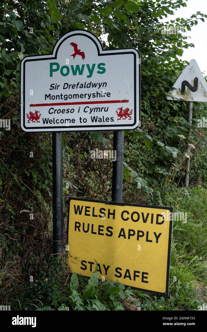 Welcome to Wales sign for Powys with COVID rules warning beneath Stock ...