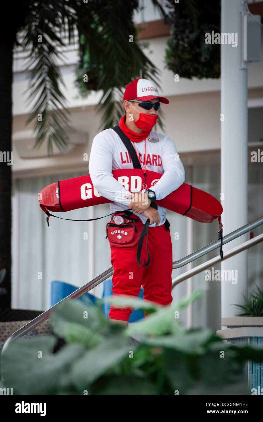 life guard standing next to a swimming pool Stock Photo - Alamy