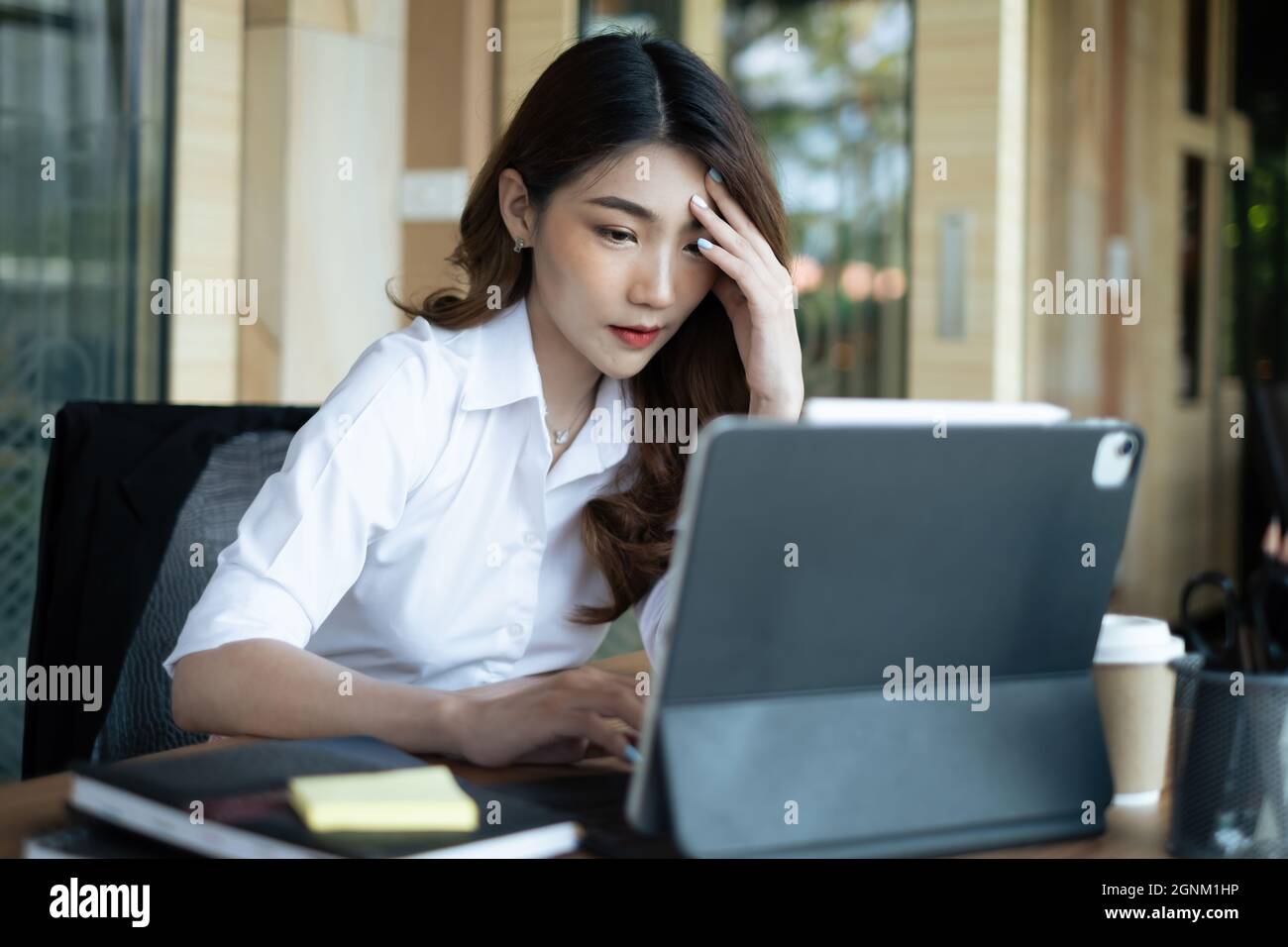 Frustrated stressed business owner or accountant sitting in an office ...