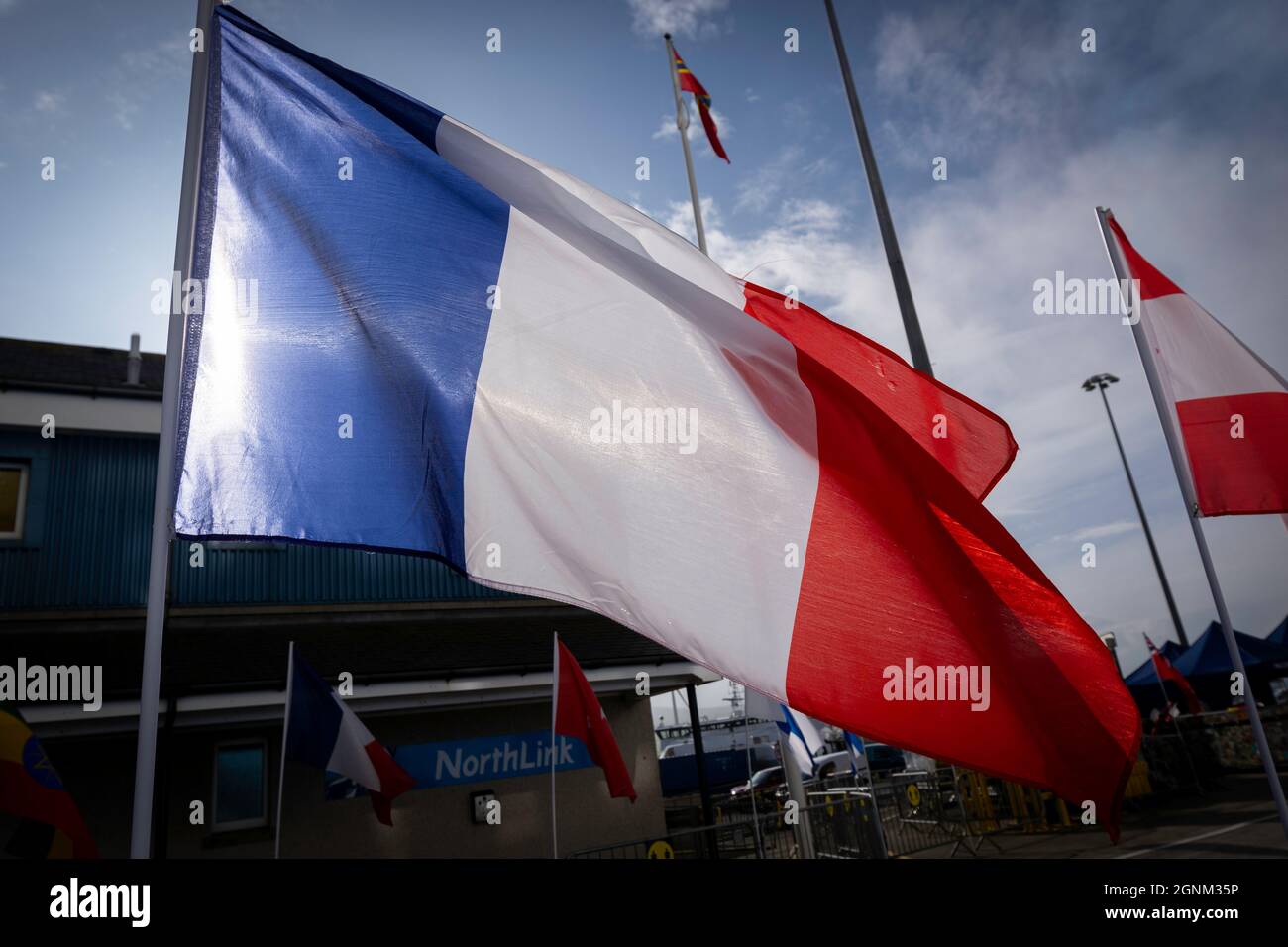 Fabric country flag waving in the wind Stock Photo - Alamy