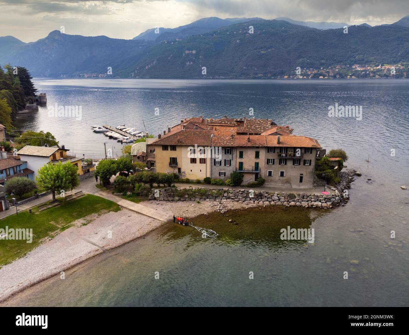 Small village located on a peninsula of Lake Como next to a marina with ...