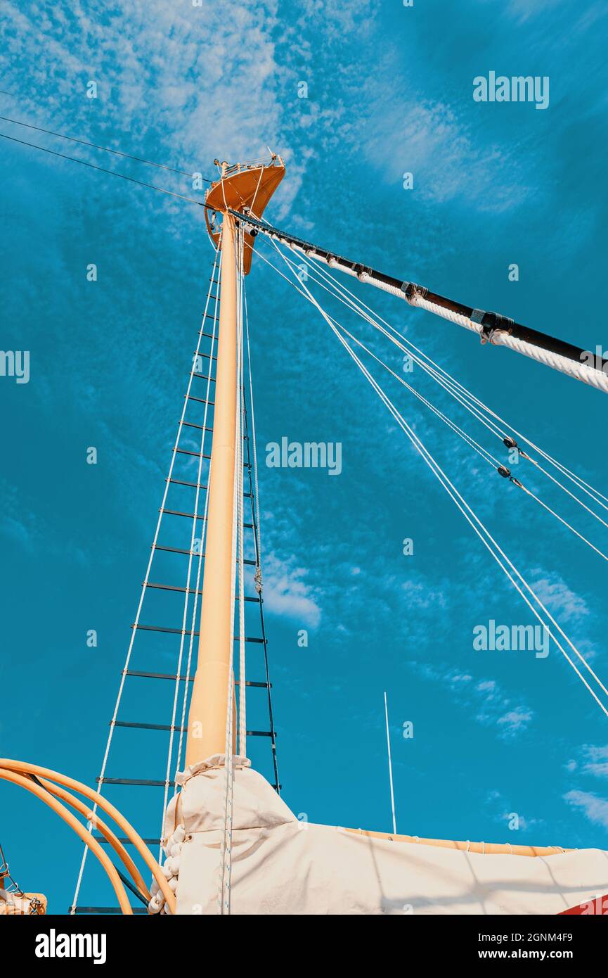 pulley with a rope on a classic sailing boat and a background of blue ...