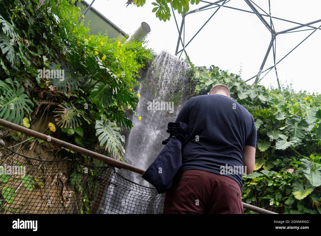 Man photographs a waterfall at the Eden Project in Cornwall, UK. 08.09. ...