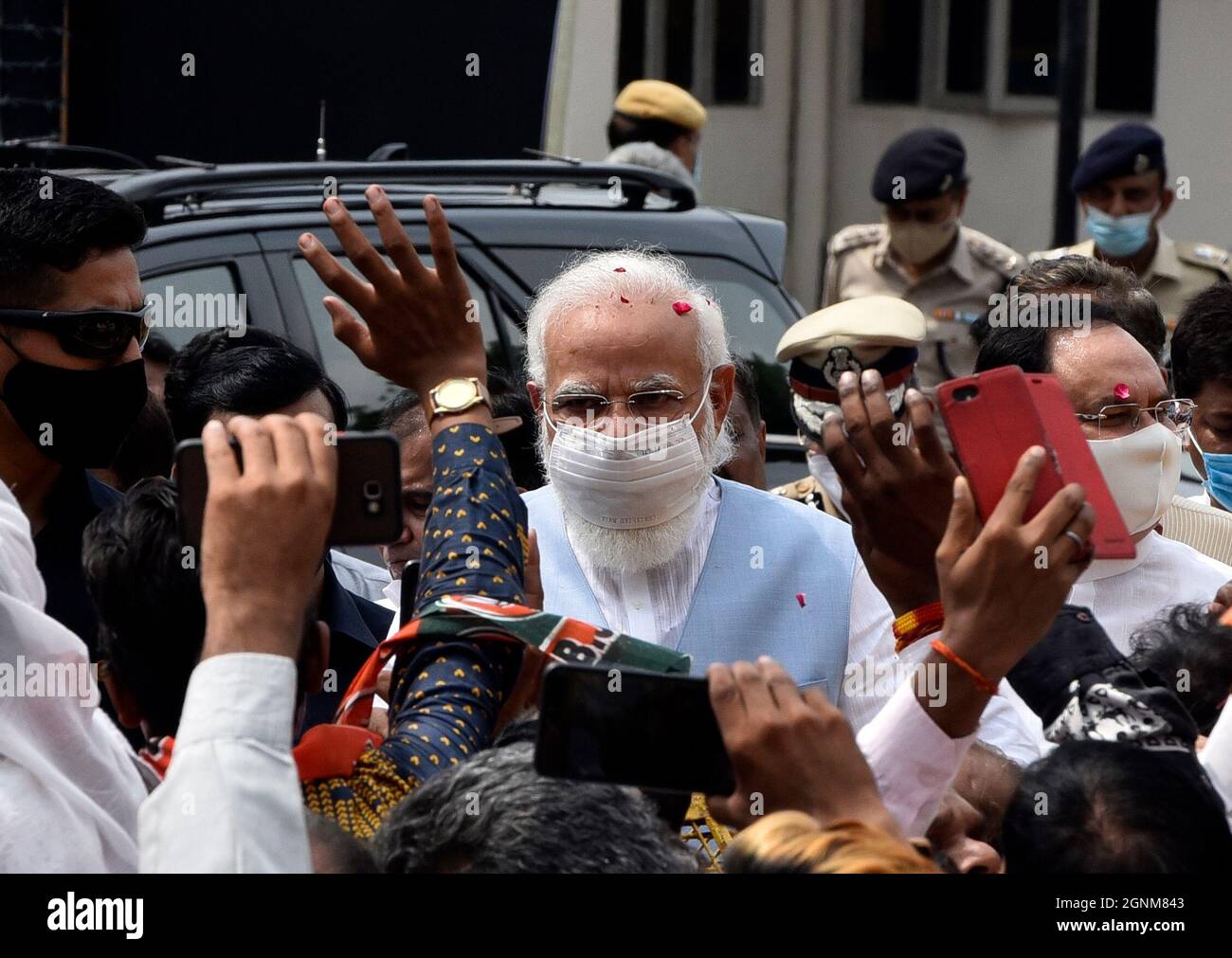 NEW DELHI, INDIA – SEPTEMBER 26: Prime Minister Narendra Modi waves at supporters upon his ...