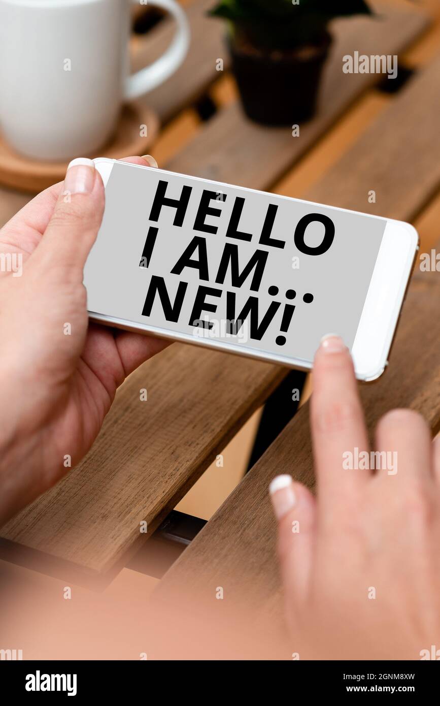 Hand writing sign Hello I Am New. Business overview used as greeting or ...