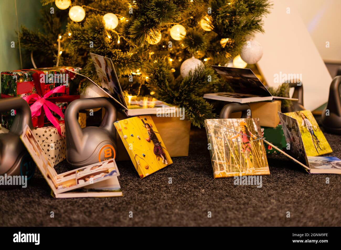 family photo album and weights for sports near the Christmas tree Stock ...