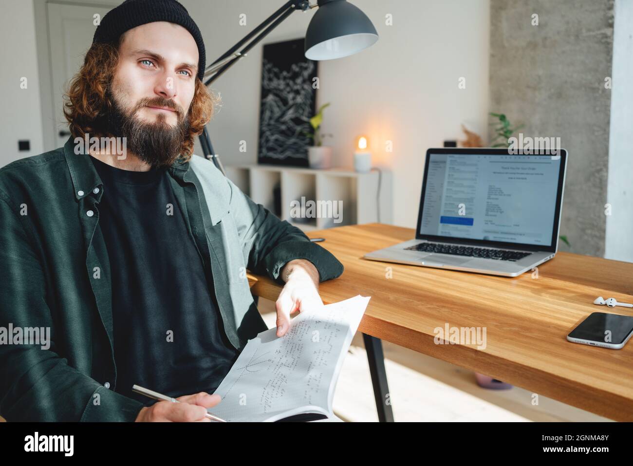 Young beard college student sit by the work table and prepare to pass ...