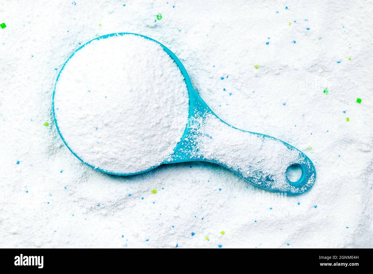 Blue cup or scoop of white powder Detergent for clothes washing. Top ...