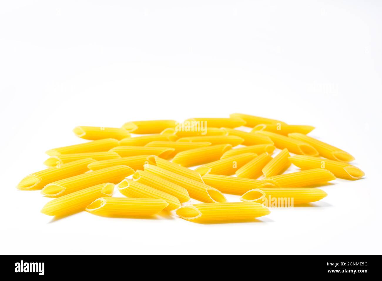 Raw uncooked Italian penne rigate pasta isolated on white background ...