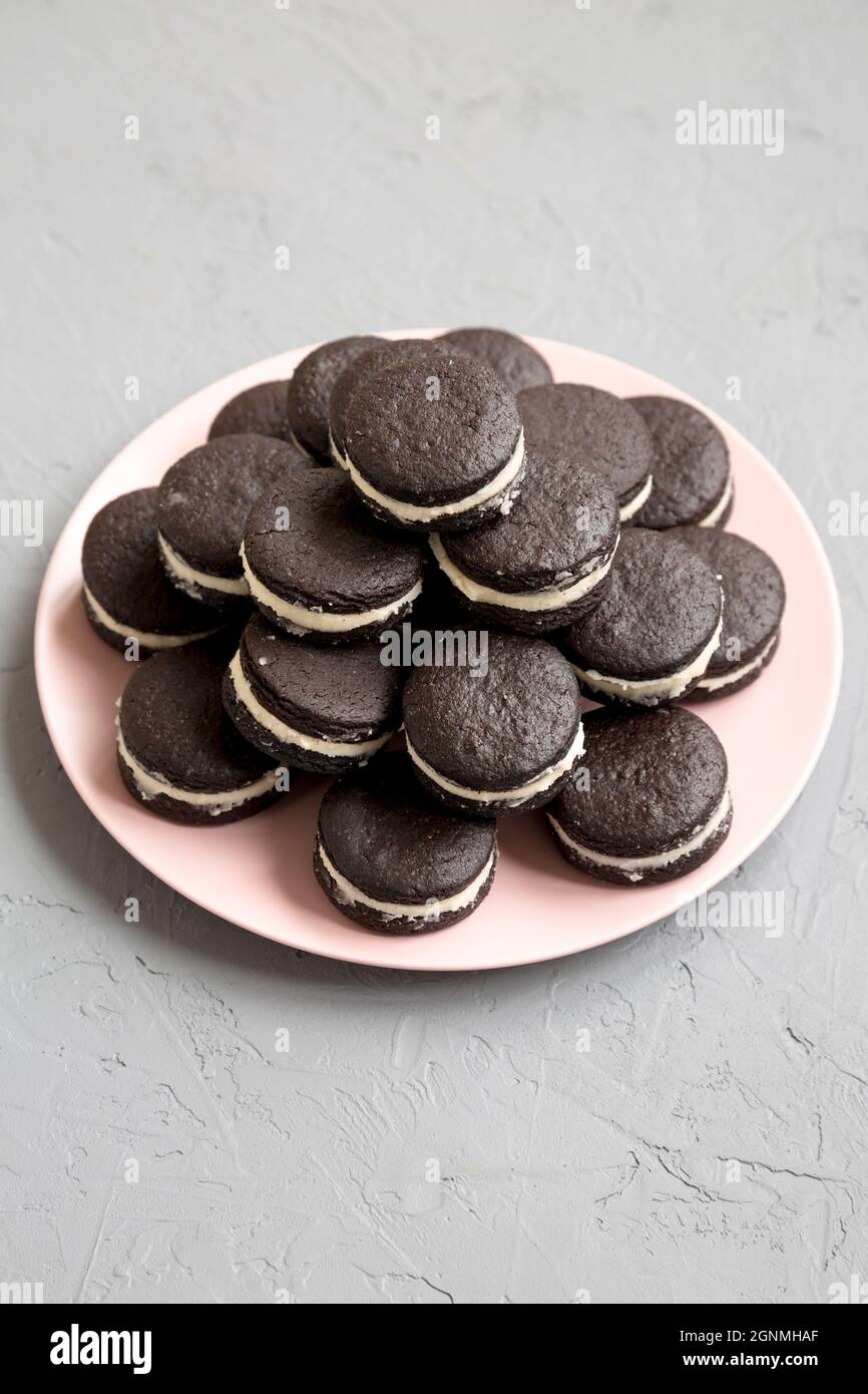 Homemade Oreos on a pink plate on a gray background, low angle view ...