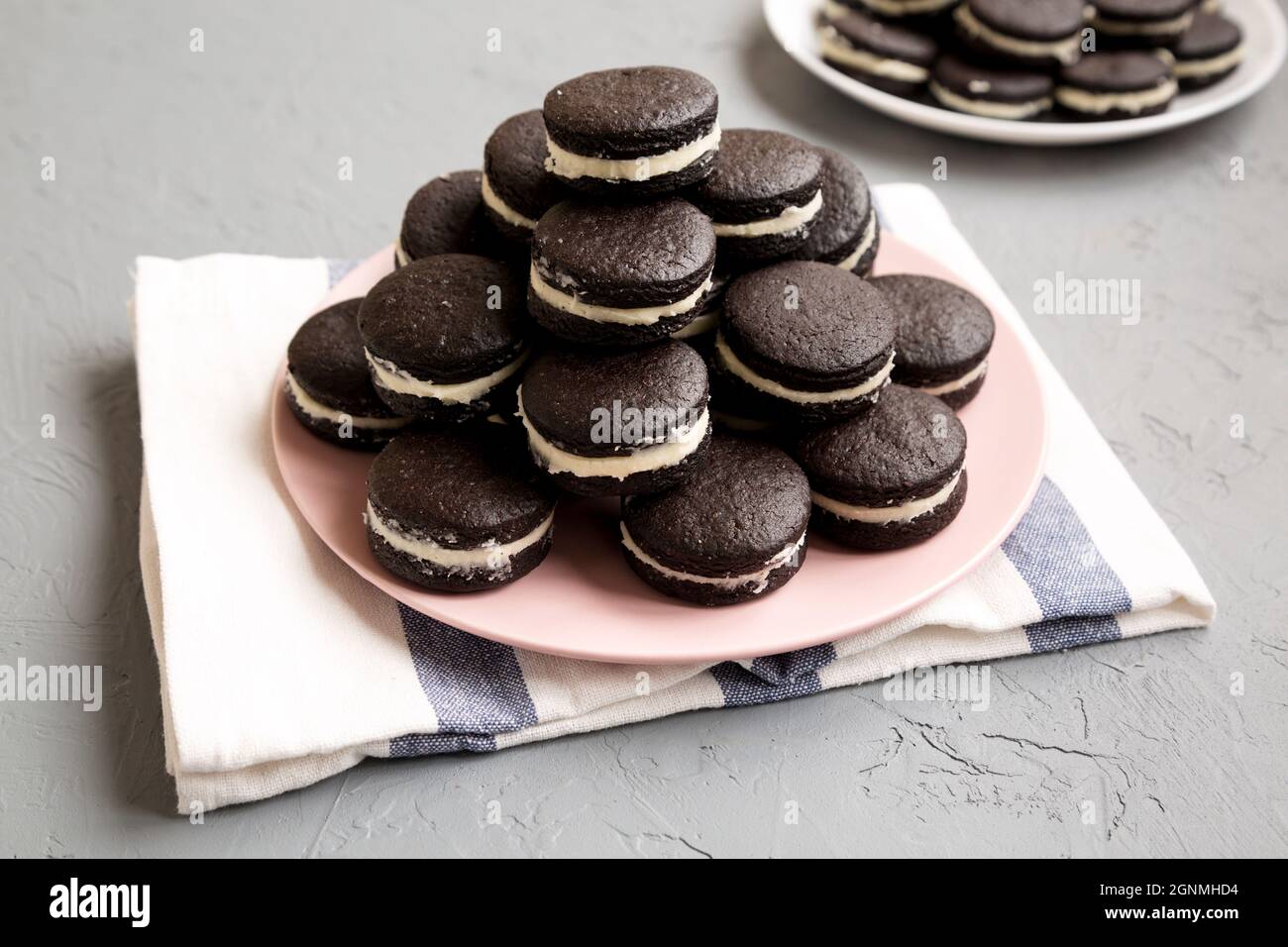 Homemade Oreos on a pink plate on a gray background, low angle view ...