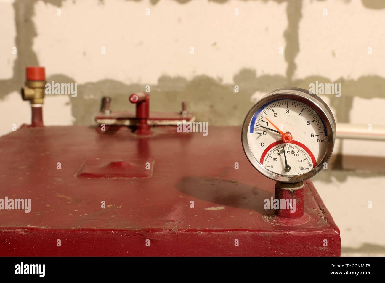 Thermometer on wood central heating system's top. Modern boiler for ...