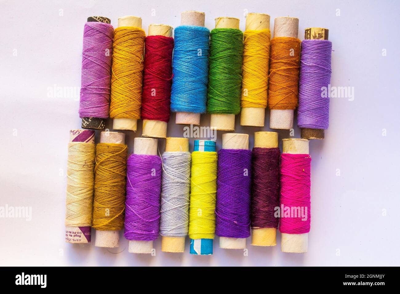 multicolour sewing thread bobbin on white background Stock Photo - Alamy