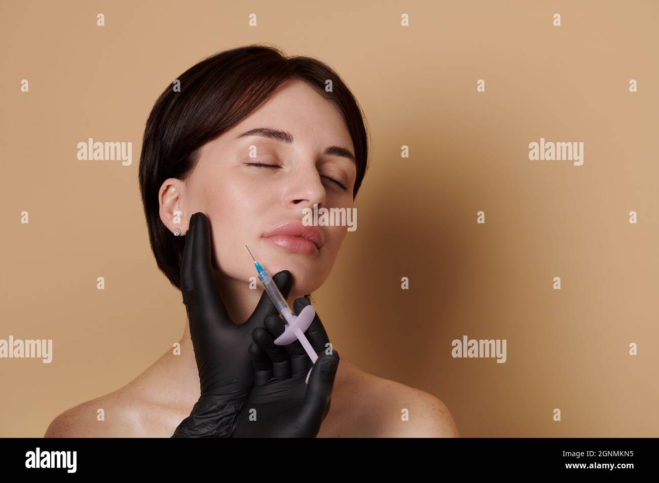 Brunette woman and hands in black medical gloves making beauty ...