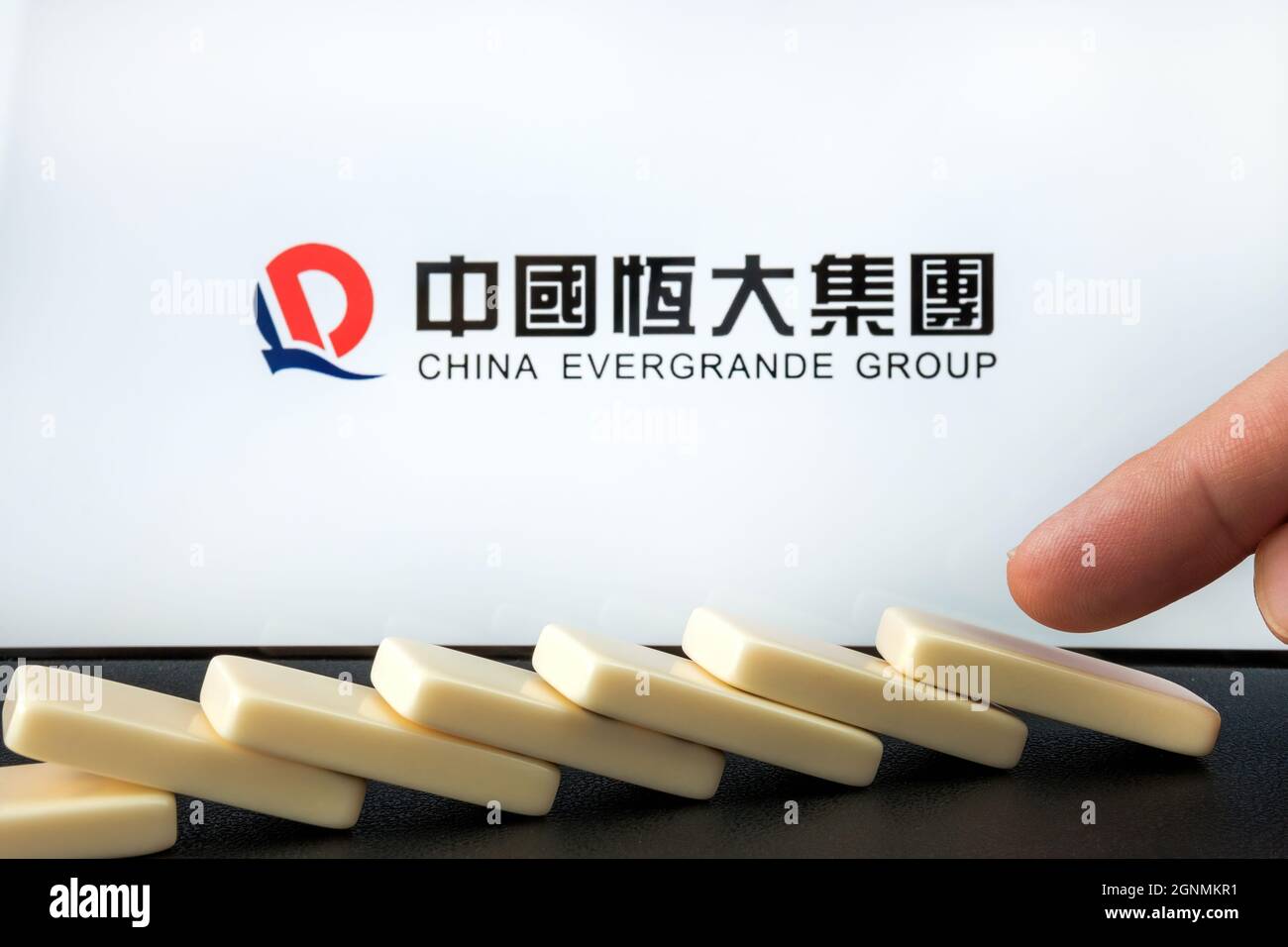 Domino blocks and blurred China Evergrande Group logo. Concept ...