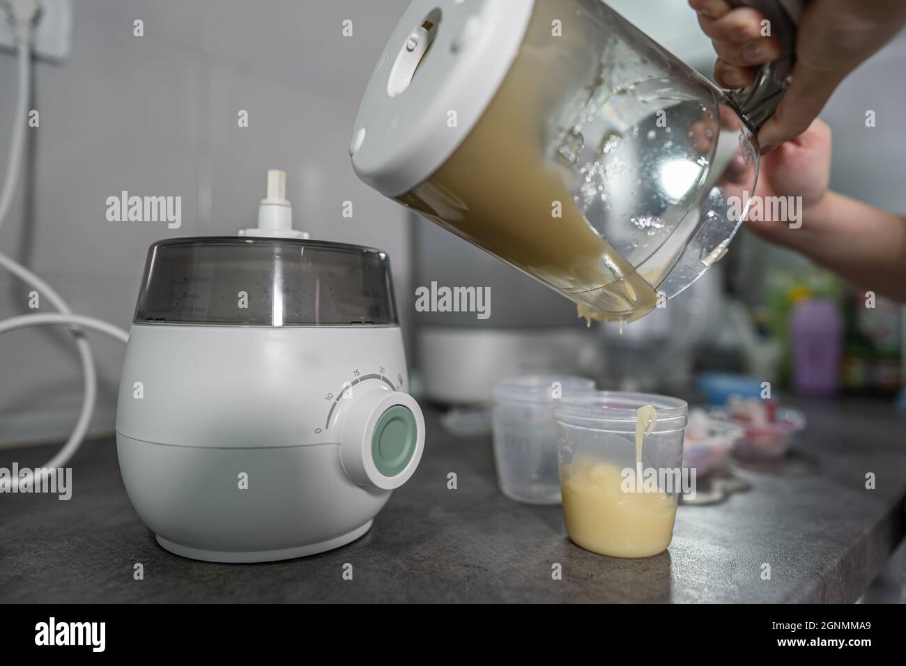Close up on the electric blender in hand of unknown woman holding it on ...