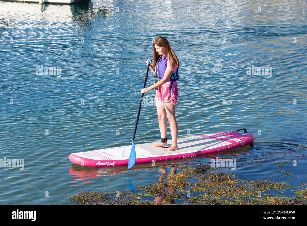Young woman paddleboarding in Portrush Harbour, Portrush (Port Rois ...