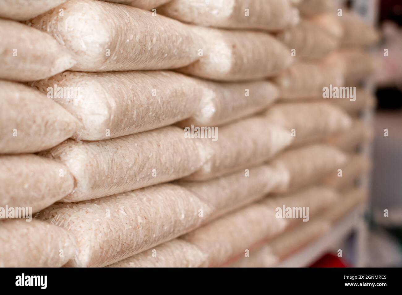 Rice. Stacking of clear bags of white rice. Rice store. Agricultural ...