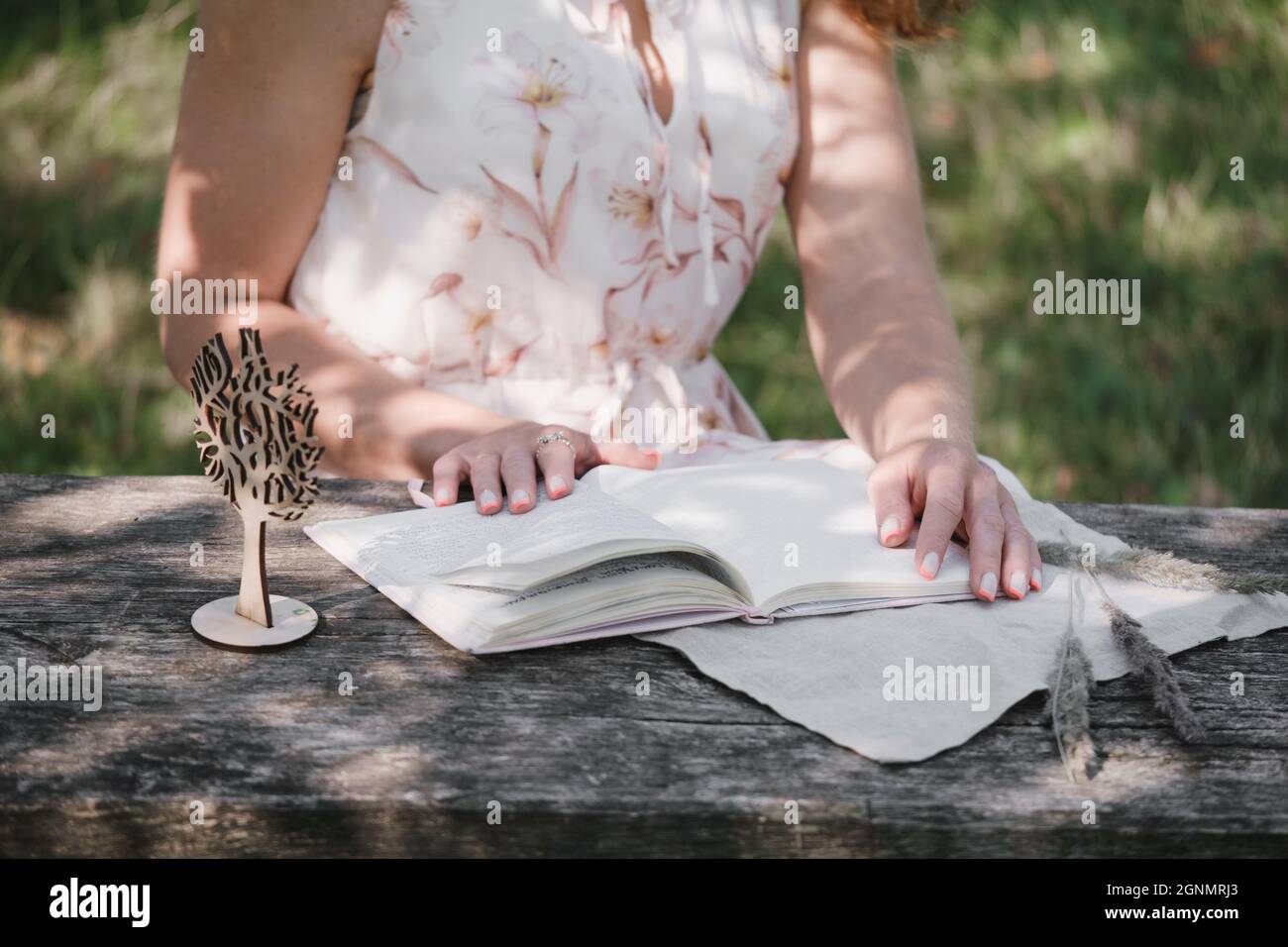Woman writing, reading diary on the wooden table. Romantic memories ...