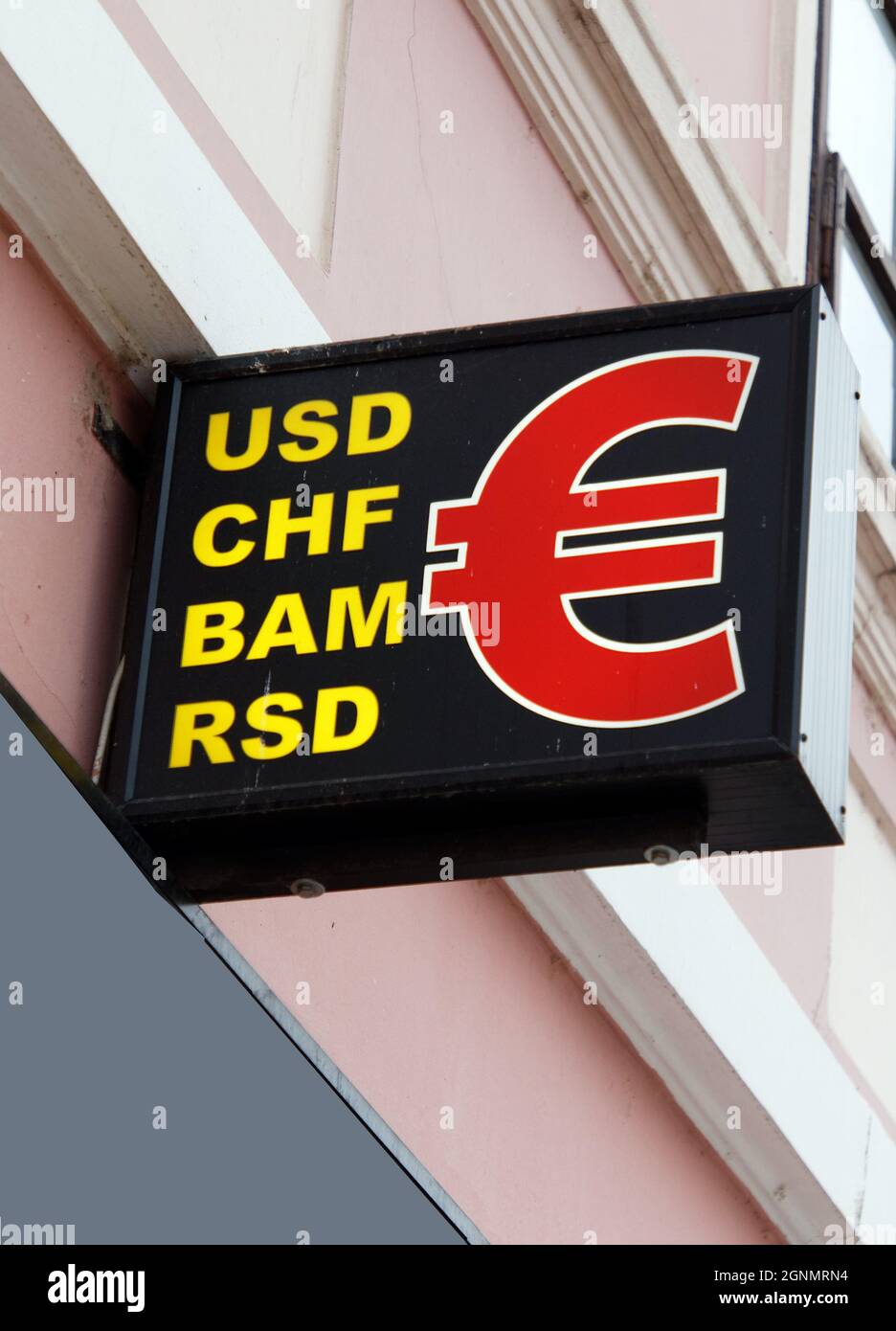 Currency exchange sign on advertising board on street building facade ...