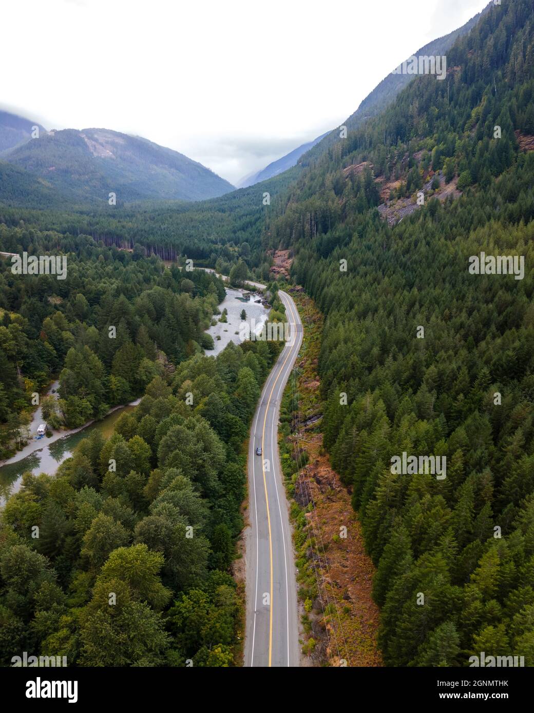 An aerial view of a highway passing through scenic green woody terrain ...