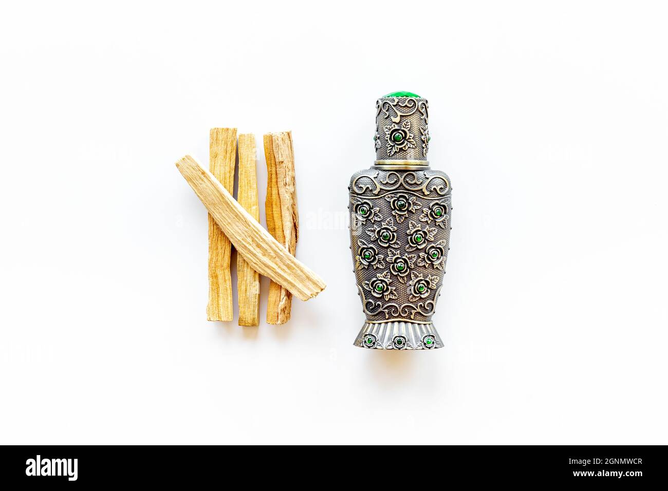 Arabic oud oil perfume in silver bottle with crystals and sticks of ...