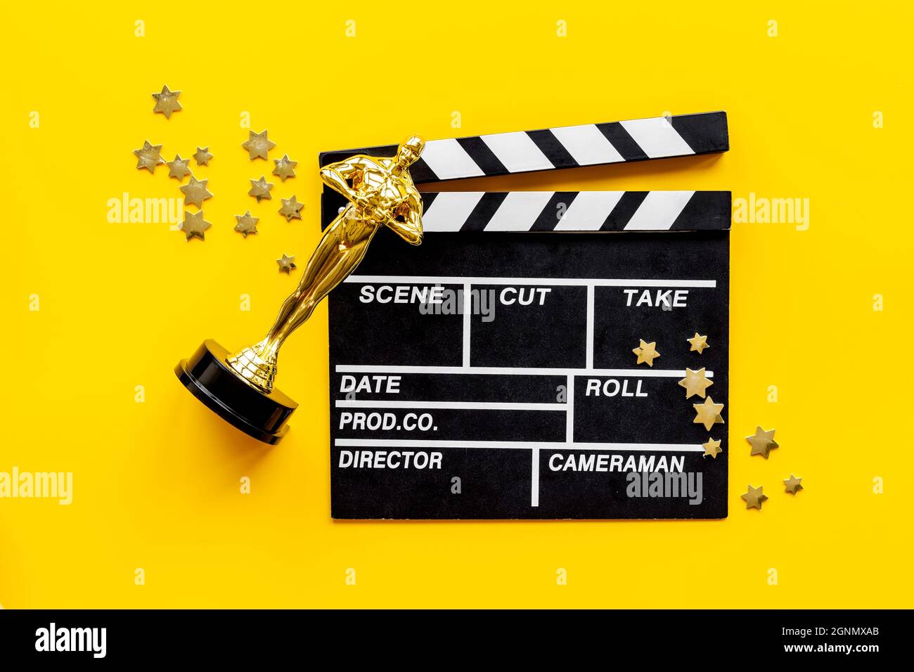 Golden movie award statue with cinema clapper board Stock Photo - Alamy