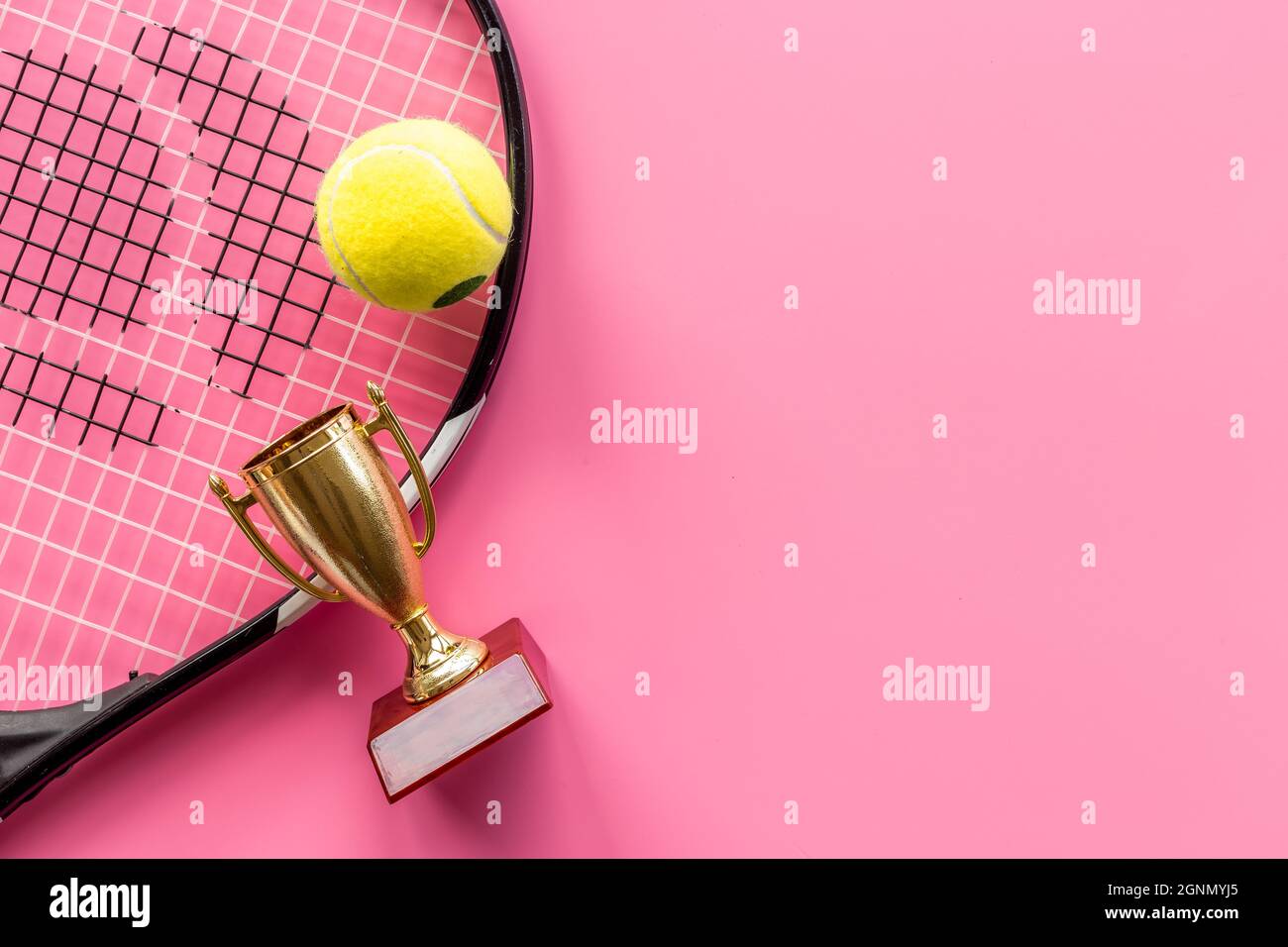 Small golden trophy cup with tennis racket and ball. Sport champion ...