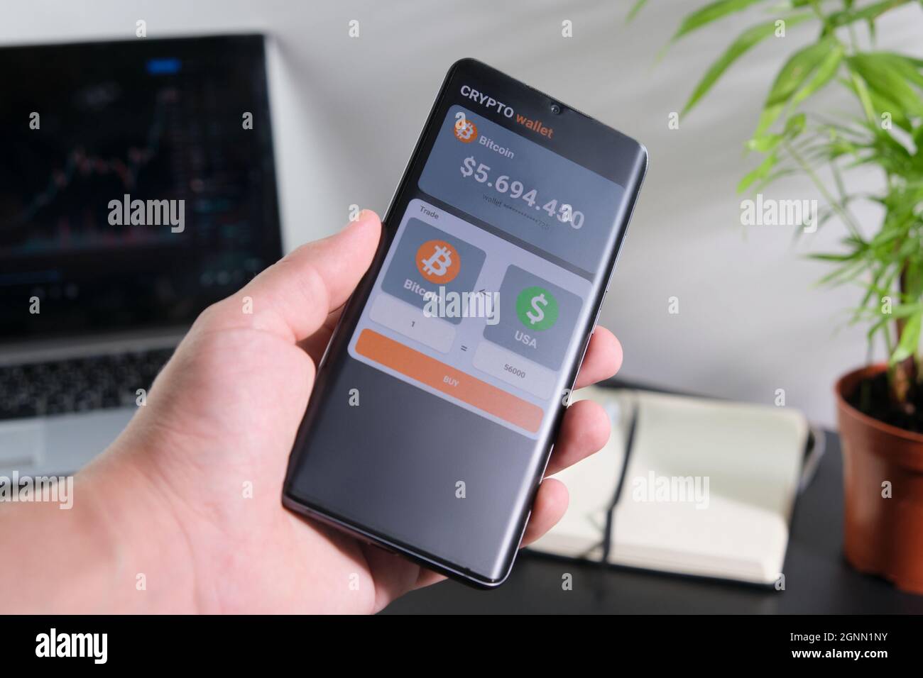 A man buys bitcoins in a mobile application. Smartphone with mobile ...