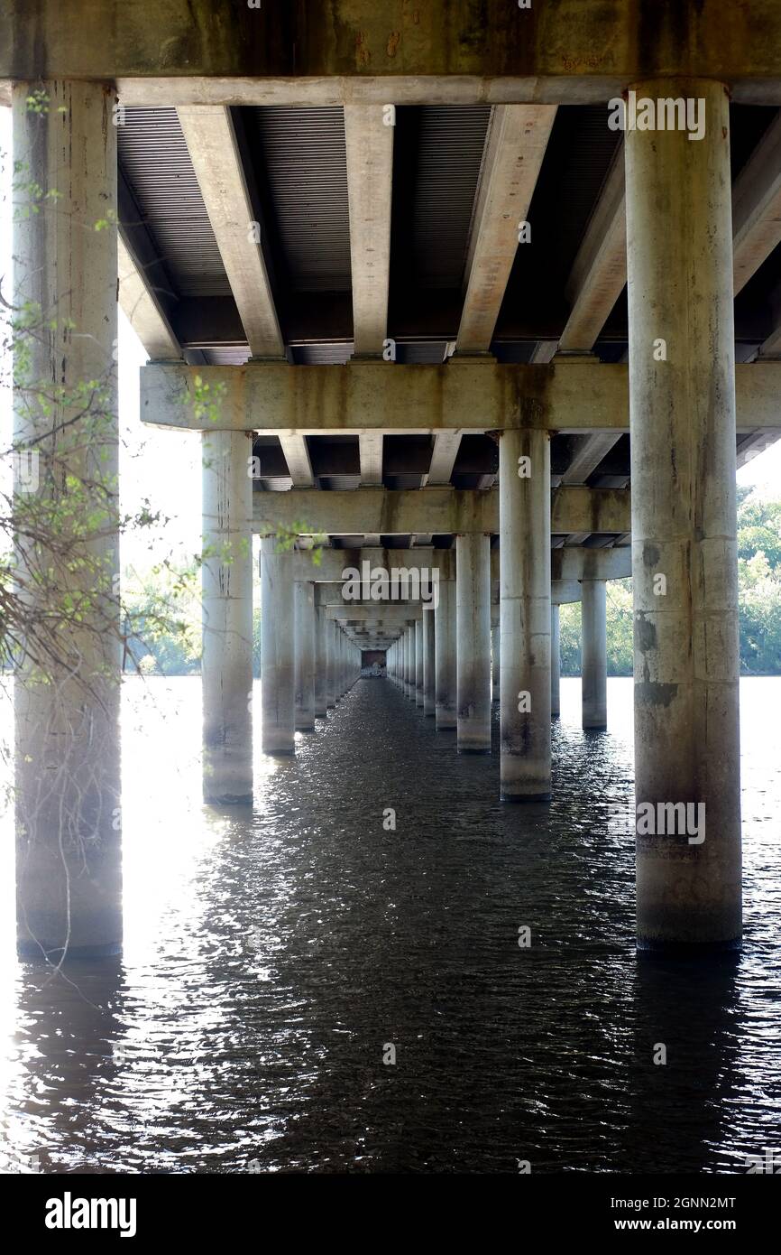underside of concrete bridge over water Stock Photo - Alamy
