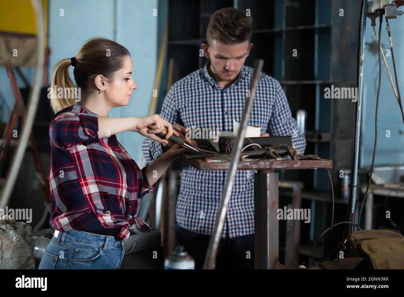 Young masters standing and working together Stock Photo - Alamy