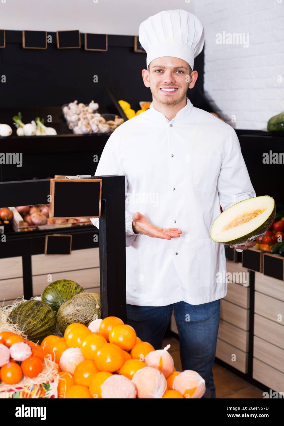 Male cook in grocery shop Stock Photo - Alamy