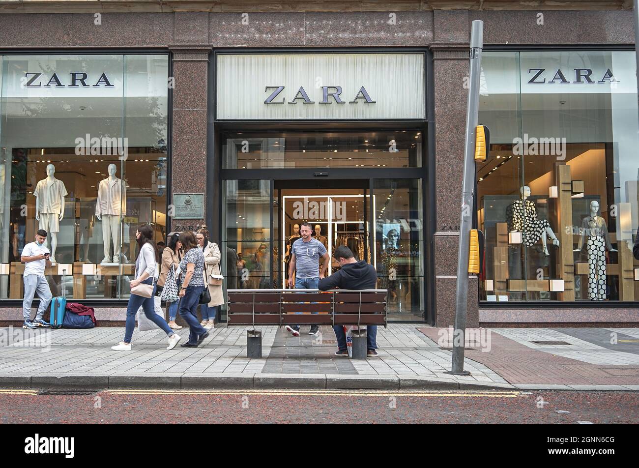 Shoppers walk by ZARA Fashion Store in Belfast Stock Photo - Alamy