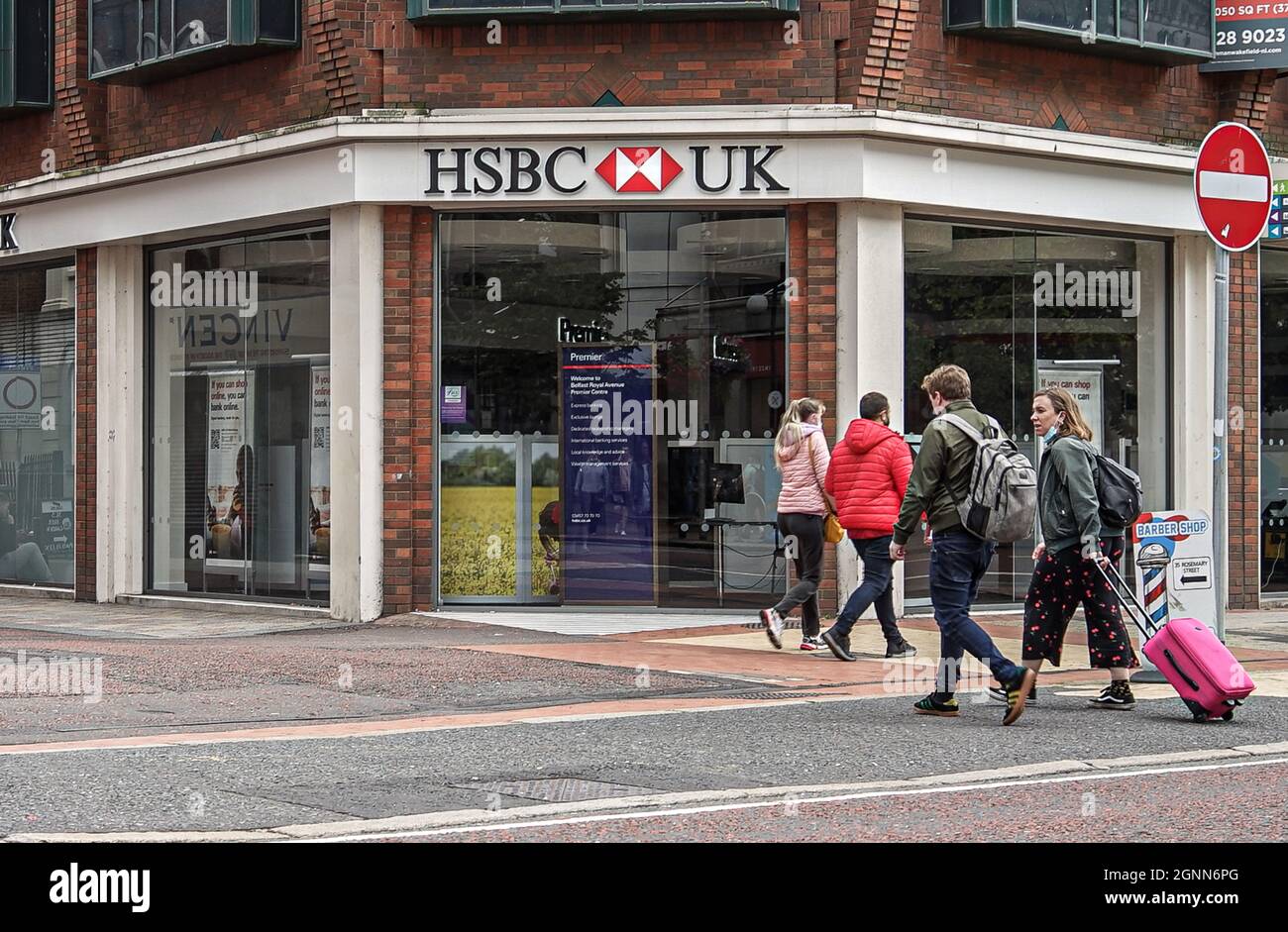 Belfast, UK. 22nd Aug, 2021. Travelers with a suitcase walking by HSBC ...