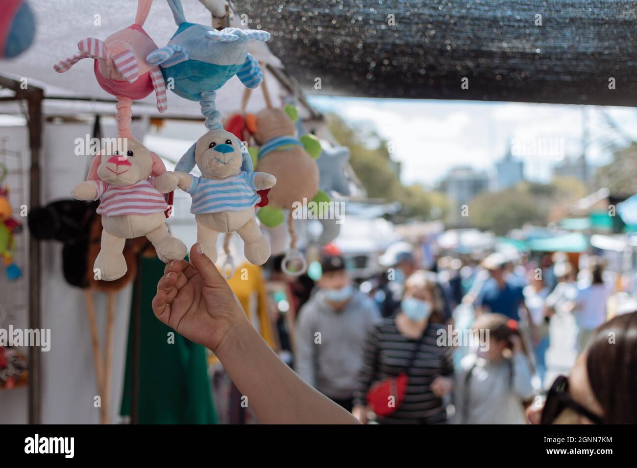 Unrecognizable woman touches baby stuffed animals with intent to buy ...