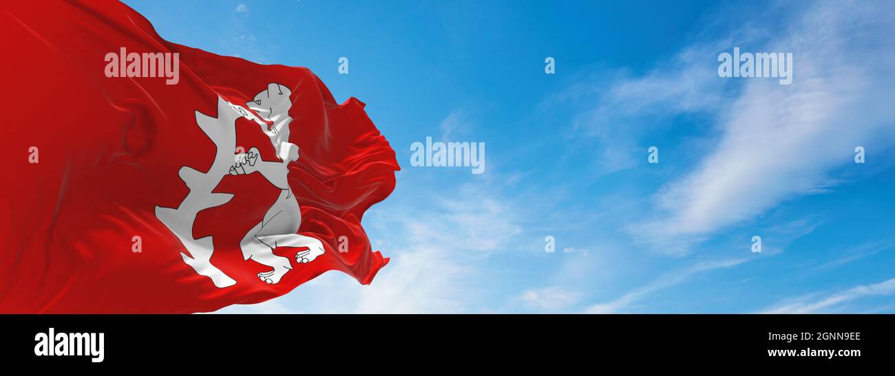 flag of county Warwickshire, UK at cloudy sky background on sunset ...