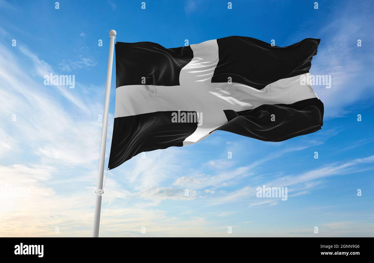 flag of county Cornwall, UK at cloudy sky background on sunset ...