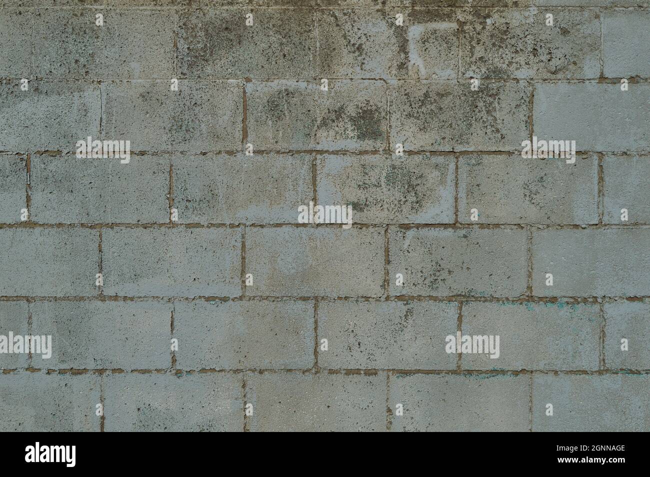 Full frame background of gritty concrete brick wall has a weathered ...