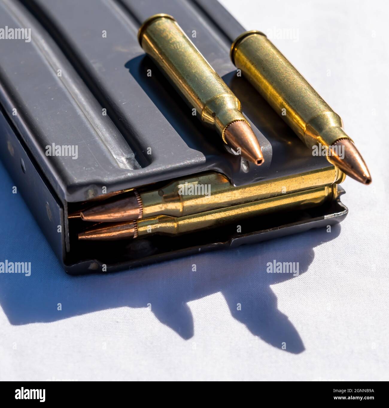 A rifle magazine loaded with 223 caliber bullets with two additional ...
