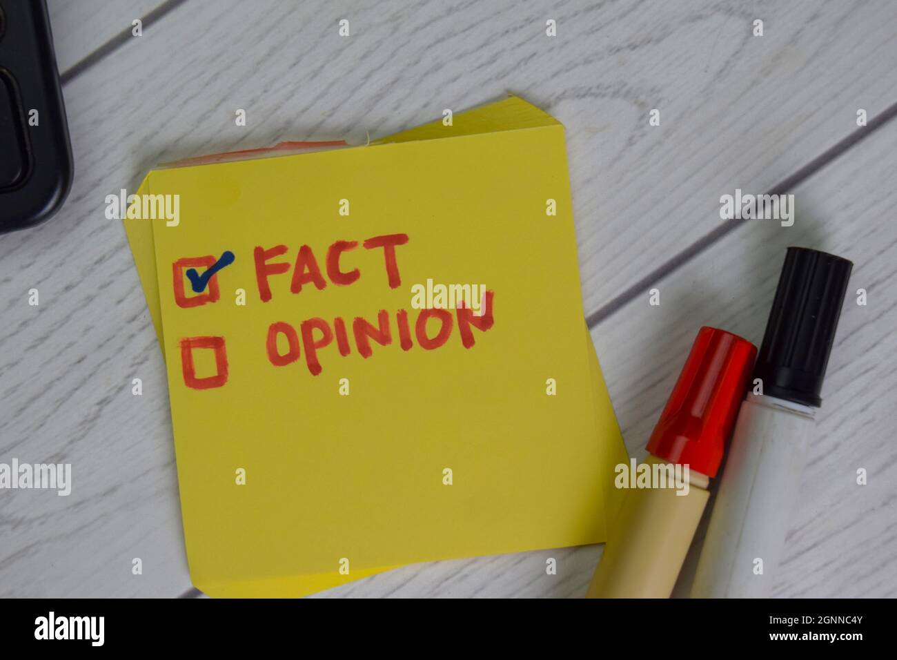 Fact and Opinion write on sticky notes isolated on Wooden Table Stock ...