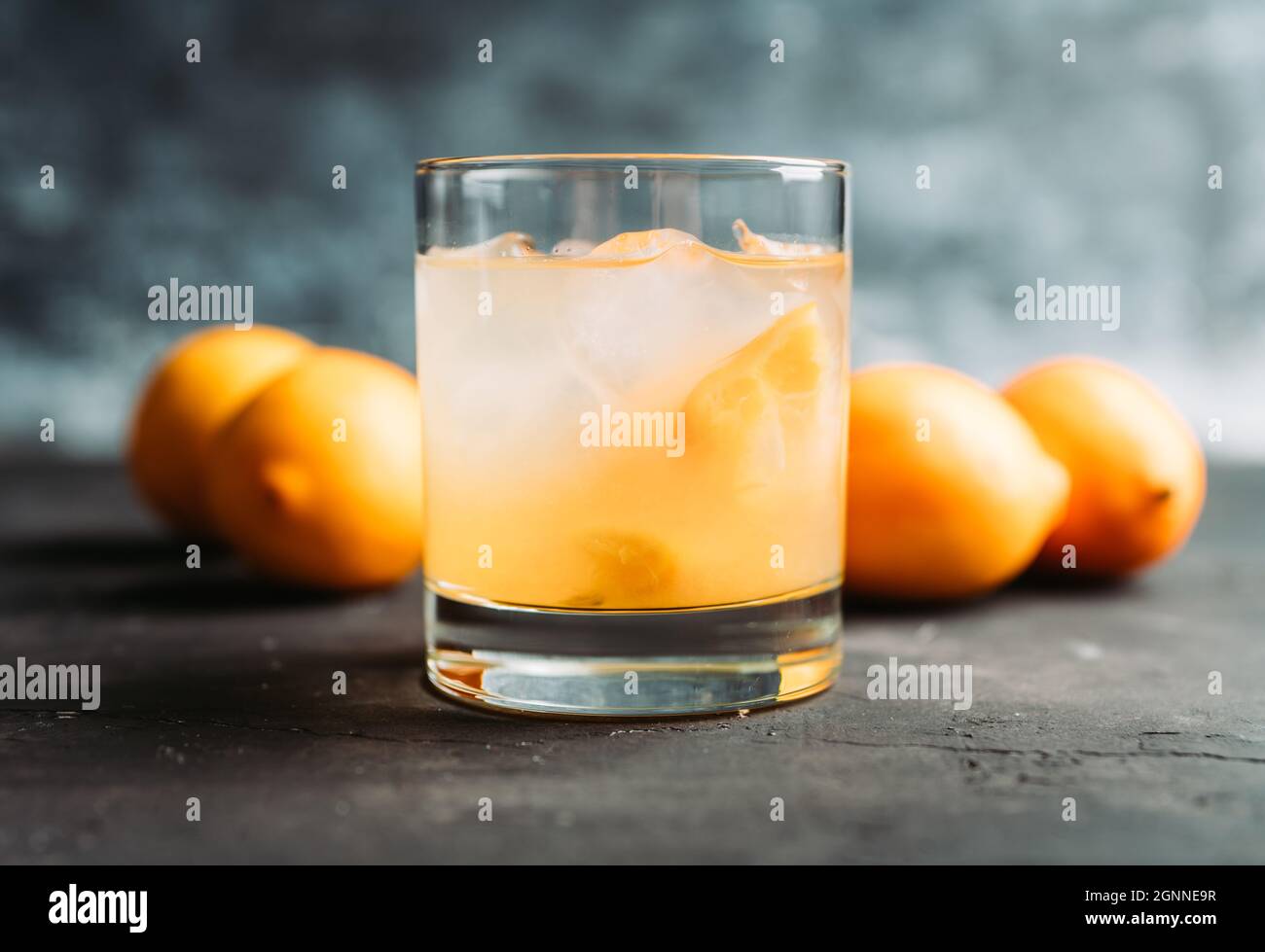 Old fashioned lemon beverage on the rustic background. Selective focus ...