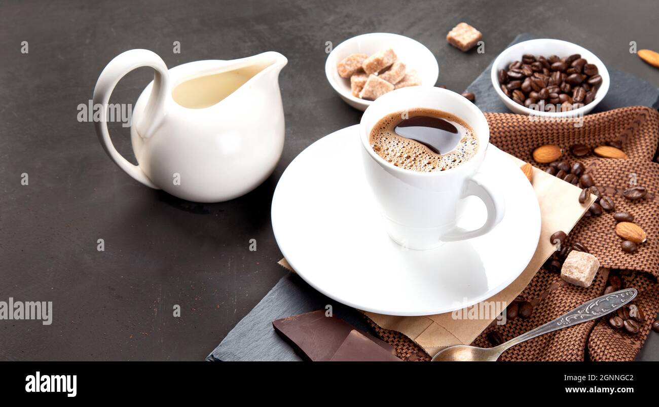 Coffee with snacks on black background. Table setting Stock Photo - Alamy