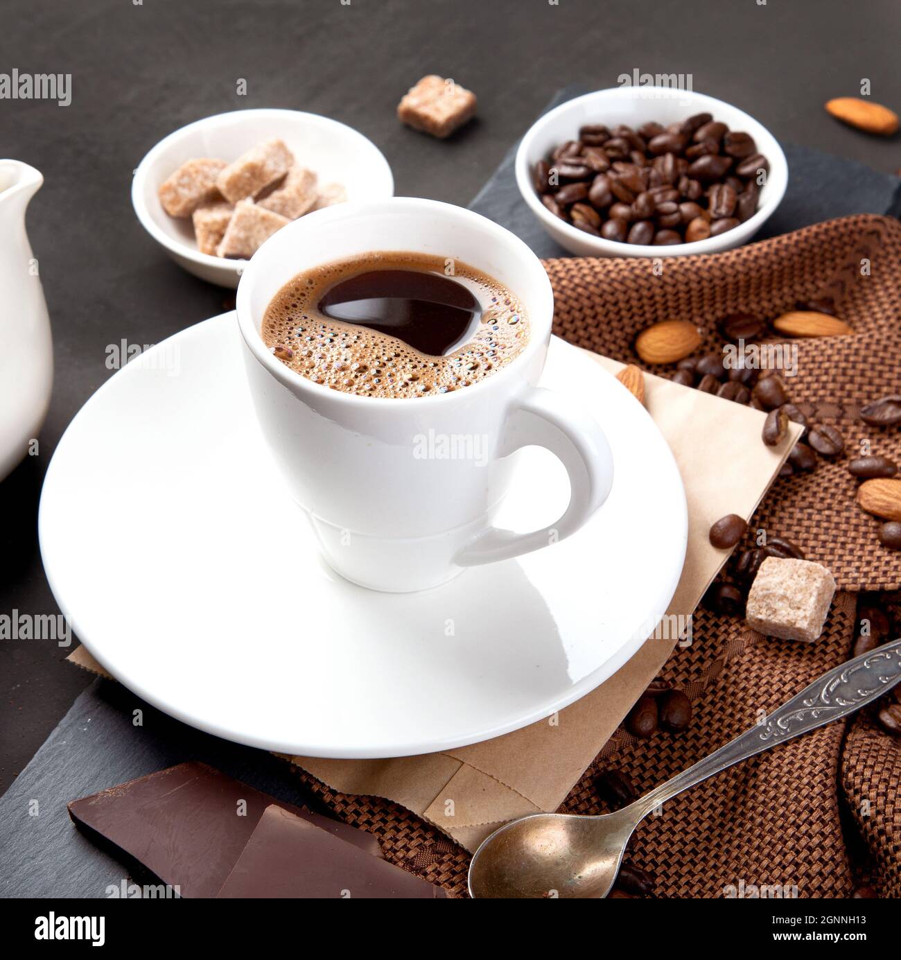 Coffee with snacks on black background. Table setting Stock Photo - Alamy
