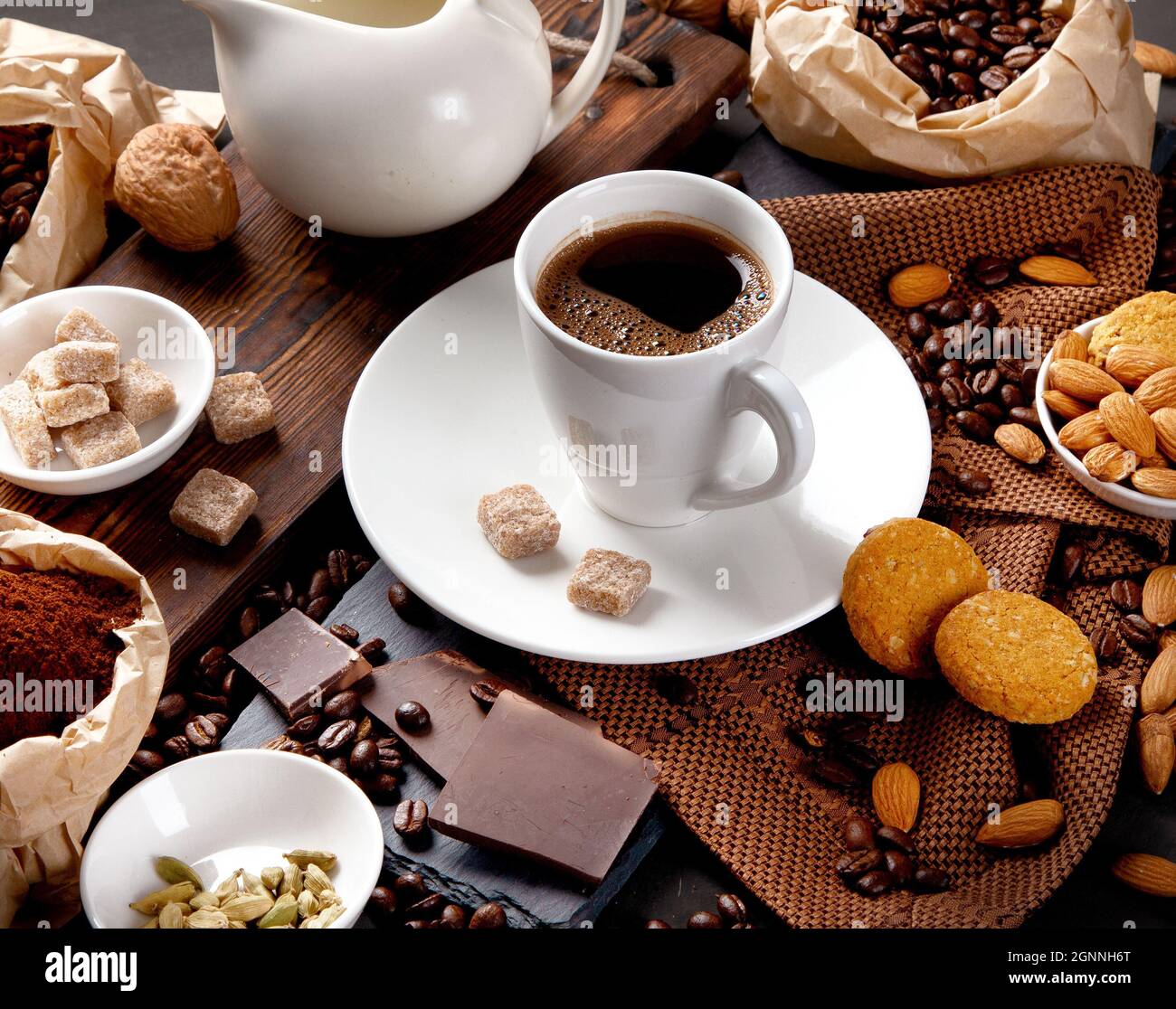 Coffee with snacks on black background. Table setting Stock Photo - Alamy