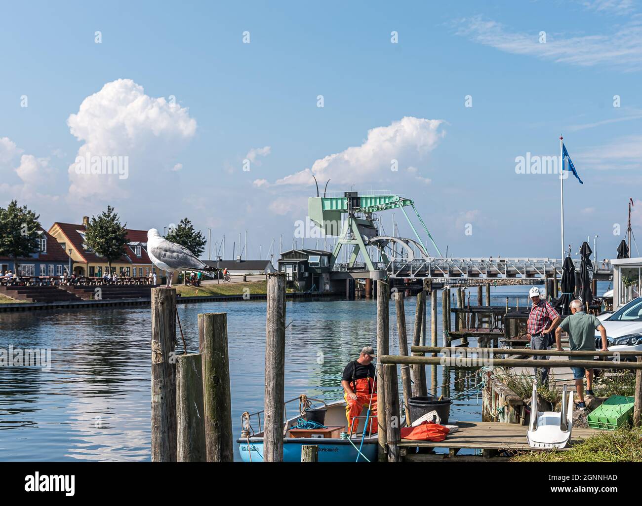 fisherman at his boat docked at a jetty, Karrebæksminde, Denmark ...